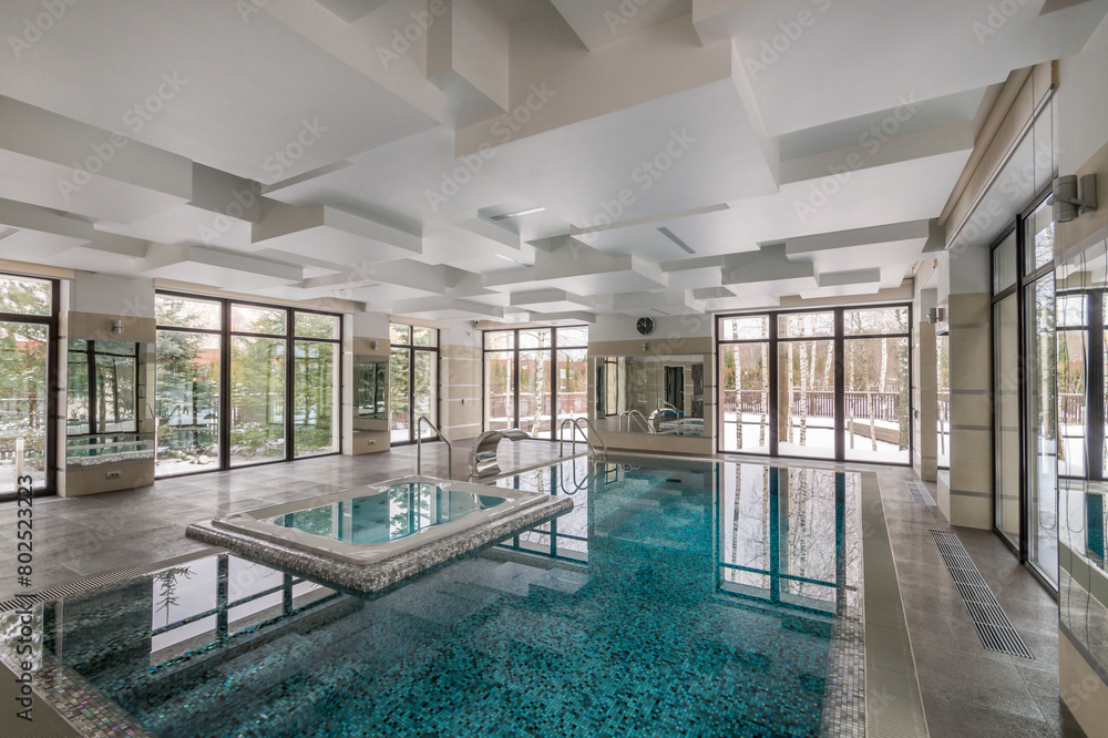 Private indoor swimming pool with Jacuzzi and waterfall jet. Panoramic ...