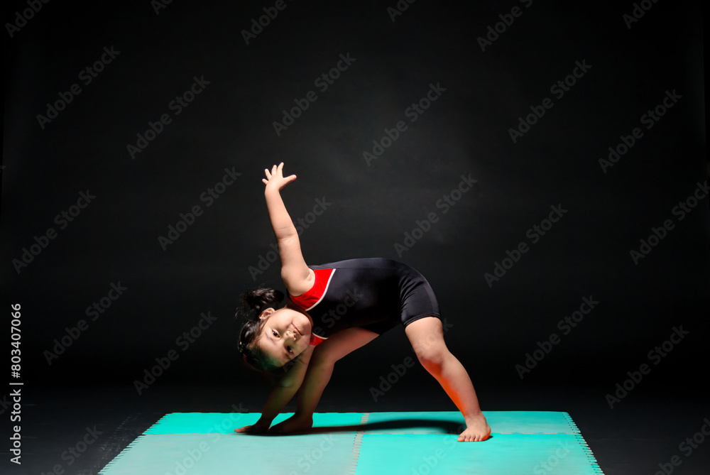 The beautiful Latin girl touches her foot with her hand, during warm-up ...