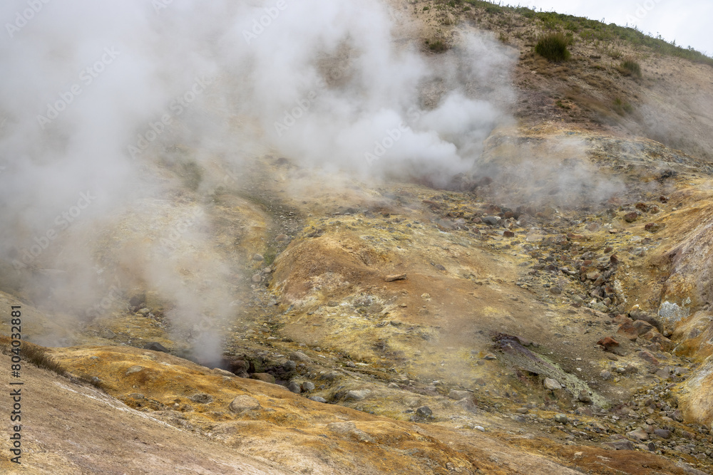 Yellow surface of soil and rocks in a mountain gorge near geothermal ...