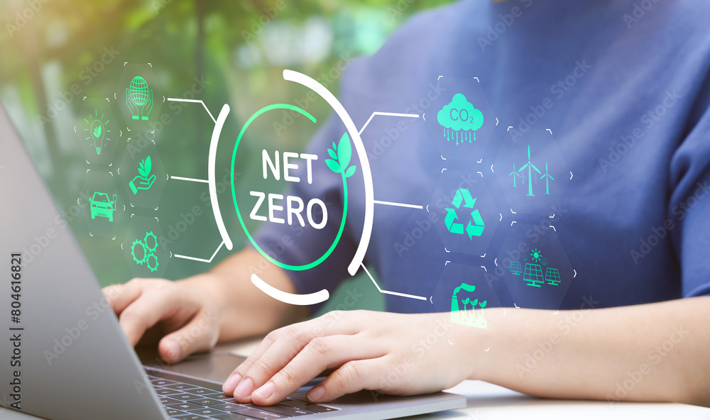 Woman use laptop with environmental carbon reduction icon or net zero ...