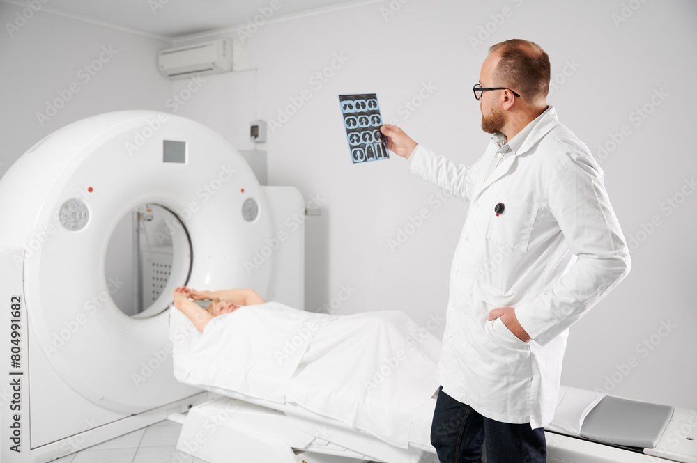 Medical computed tomography or MRI scanner. Doctor holding and ...