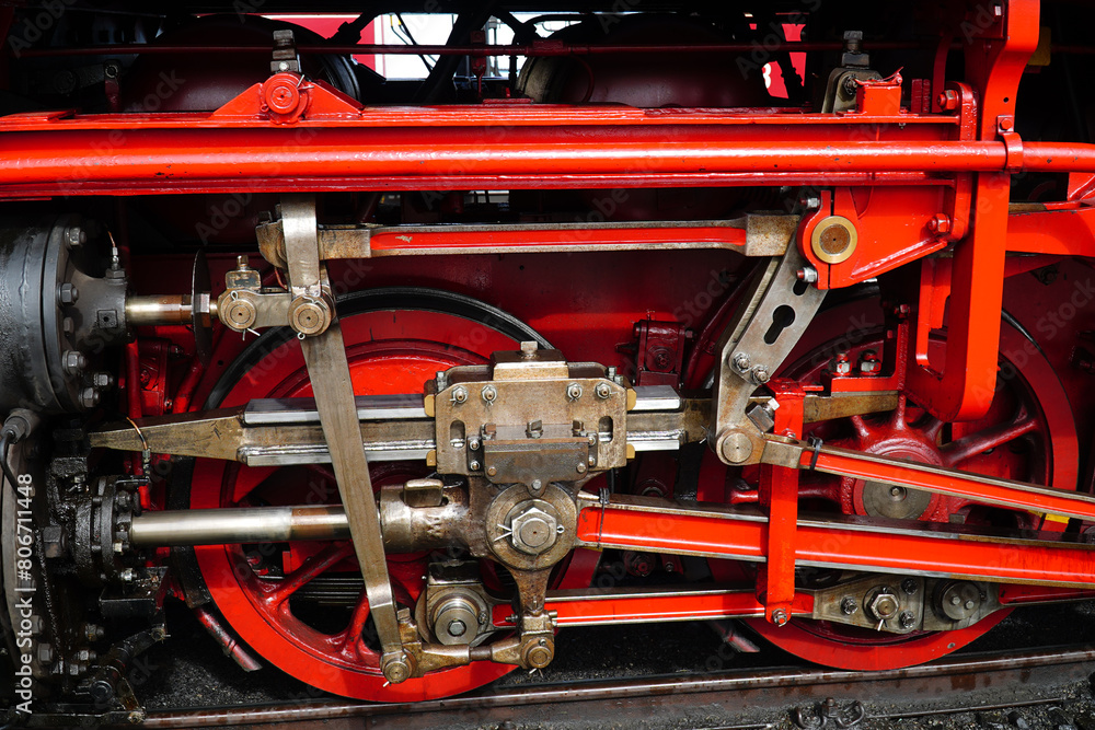 Black and red iron wheels with drive rods of the traditional steam ...