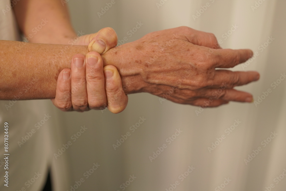 A woman uses her other hand to feel pain. and tingling along with ...