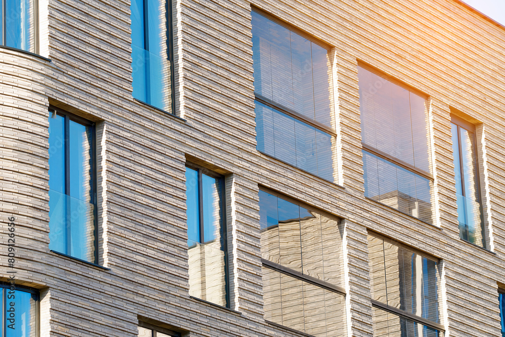 Clinker brick wall facade of residential building with multiple windows ...