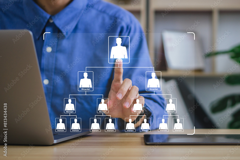 Businessman touching organization chart with hierarchy structure of teams and employees in ...