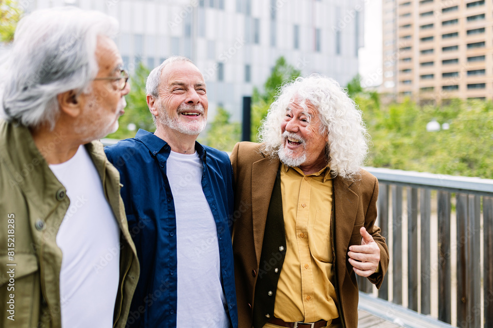 Happy senior men having fun together walking outdoors. Three older male ...