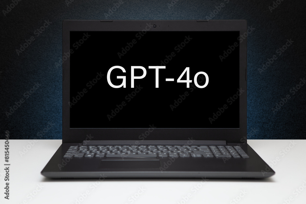 GPT-4o logo on screen laptop computer on black textured wall ...