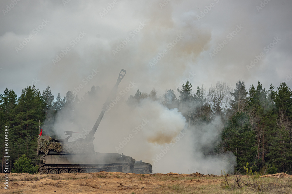 firing self propelled howitzer in the smoke Stock Photo | Adobe Stock