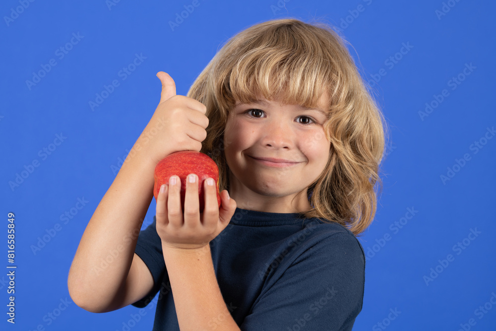 Healthy eating. Kid with thumbs up eating apple. Portrait of of cute ...