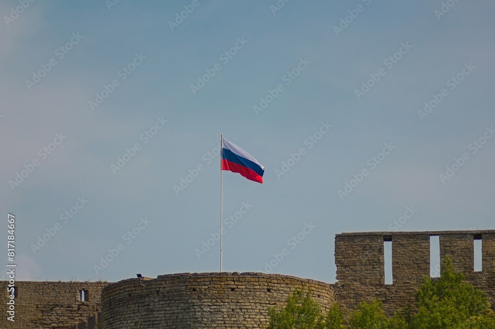 Russian flag flying above ancient fortress, symbolizing rich history ...