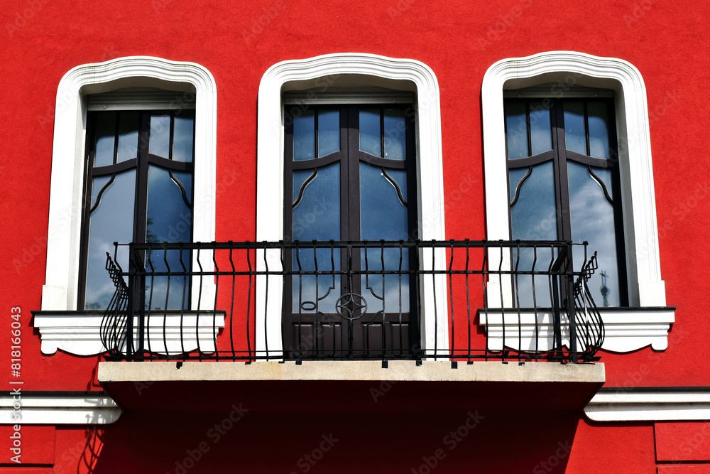 red stucco building elevation detail with wrought iron balustrade and ...