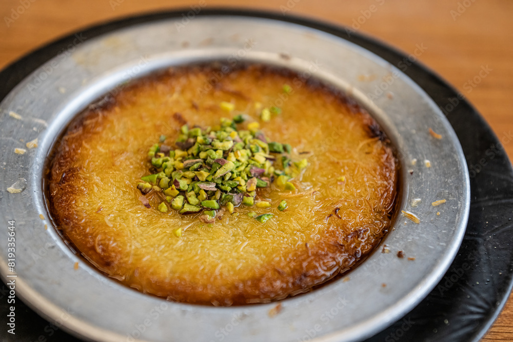 Delicious traditional Turkish kunefe with pistachio on it. Served hot ...