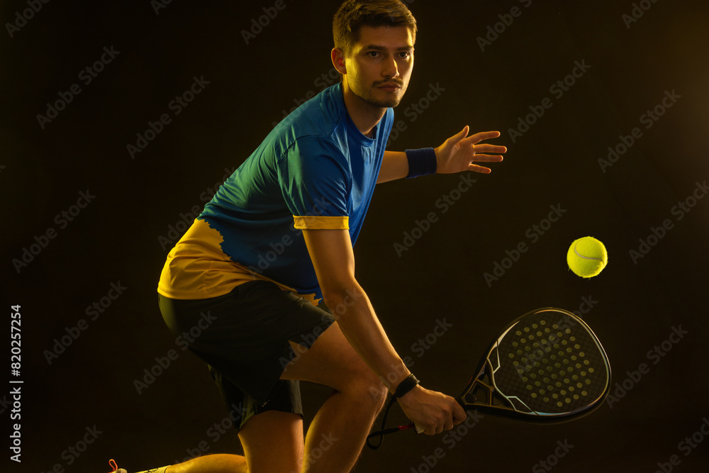 Padel Tennis Player with Racket in Hand. Paddle tenis, on a black ...