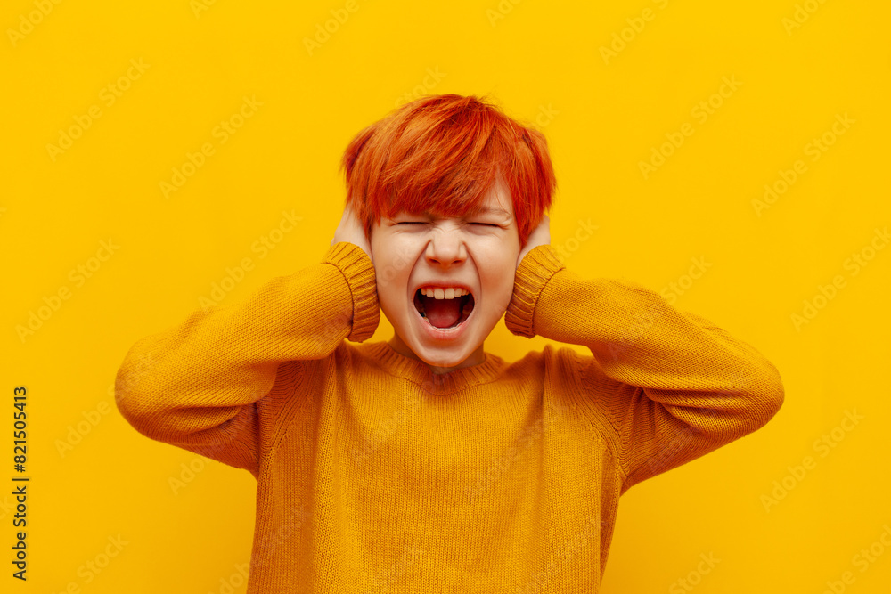 scared red-haired teenage boy screaming in stress and covering his ears ...