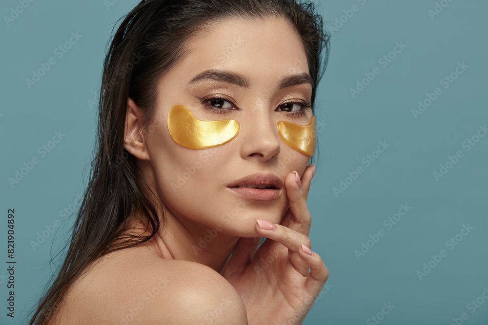 Well groomed girl applying under eyes mask with patches. Stock Photo ...