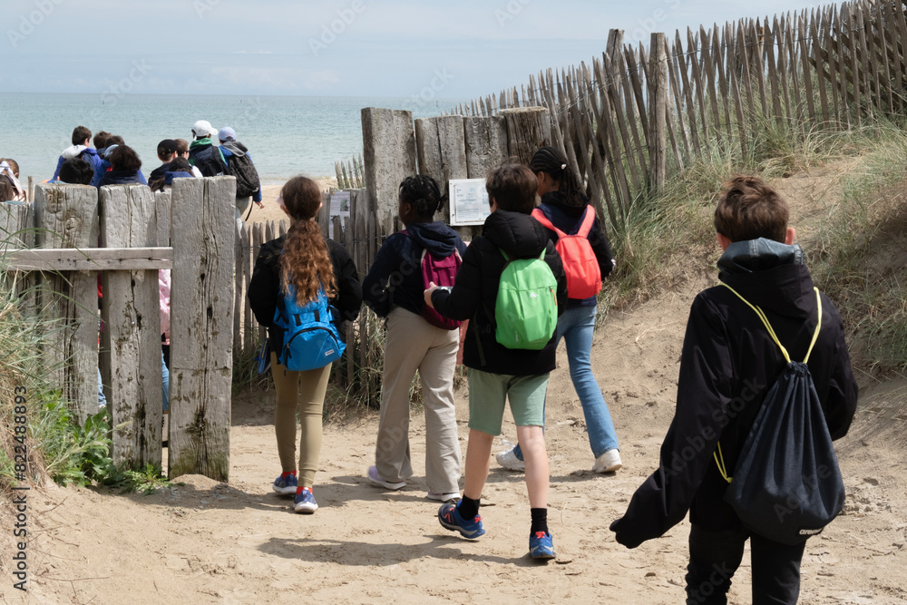 Utah Beach in Normandy, France. Unrecognizable children passing through ...