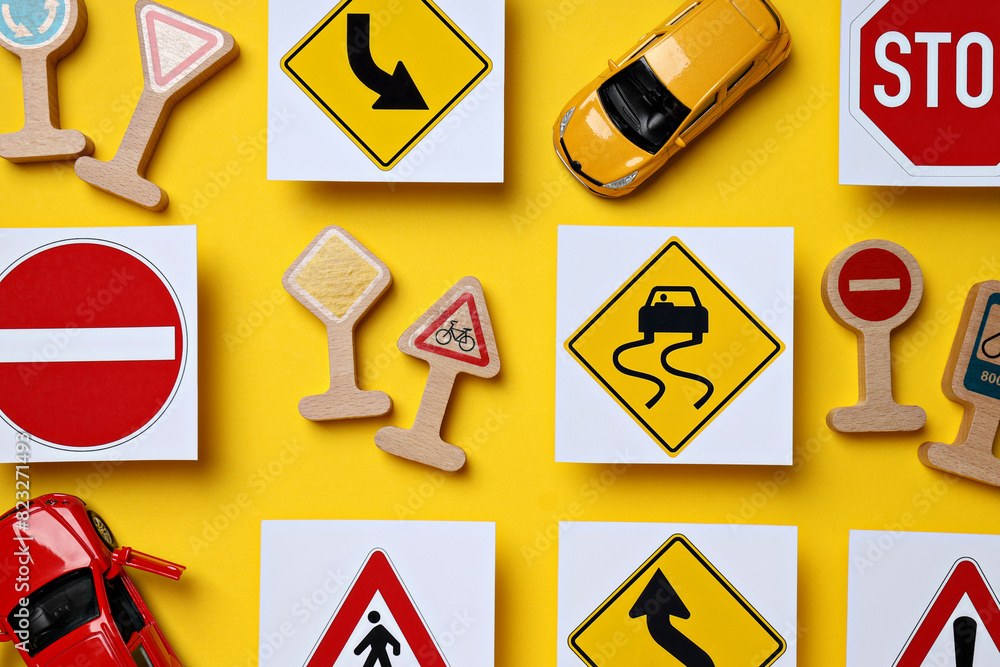 Road signs and vehicles on a yellow background. Stock Photo | Adobe Stock