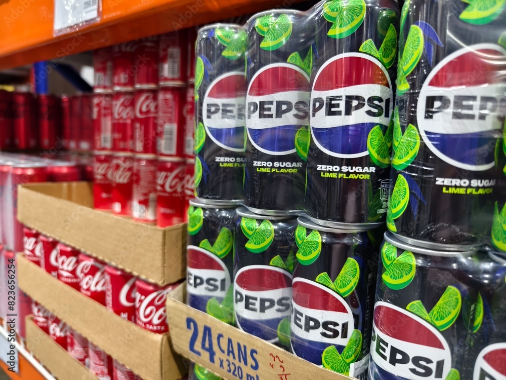 Pepsi and Coca-Cola cans in a supermarket aisle with zero sugar lime ...