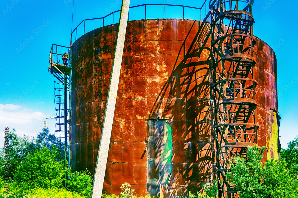 Old rusty oil tanks (fuel reservoir, oil barrel). Evidence of economic ...
