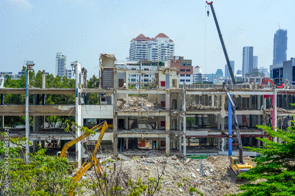 Demolition of dilapidated housing for new development among a modern ...