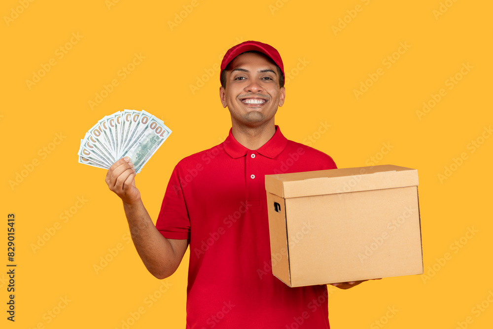 A cheerful delivery guy dressed in a red uniform proudly displays a fan ...