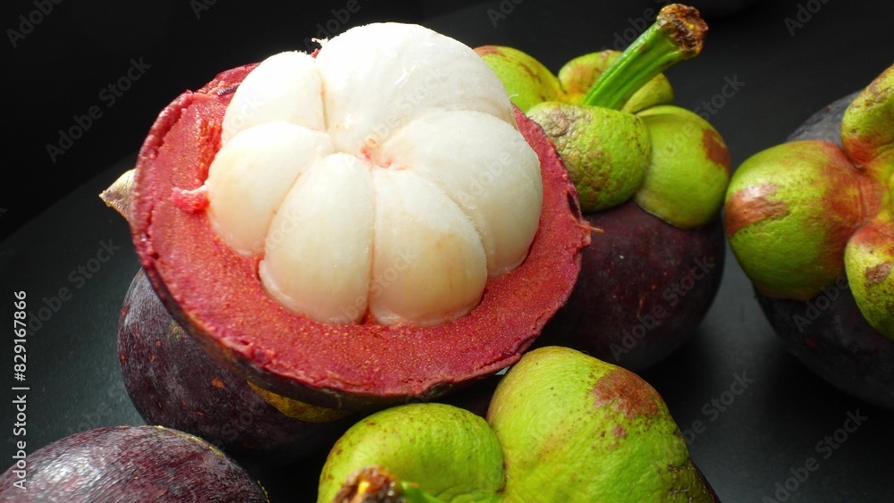 Mangosteen, the "queen of fruits," boasts a regal purple rind enfolding ...