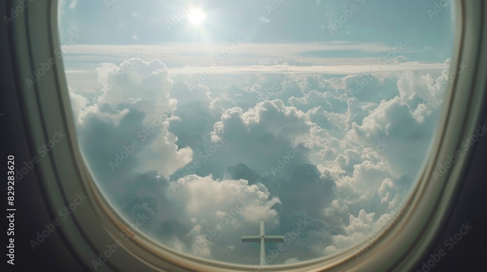 Clouds outside the airplane window, vaguely seeing the cross, religious ...