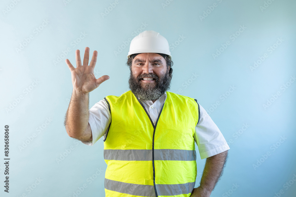 smiling adult man engineer with beard and wearing helmet and safety ...
