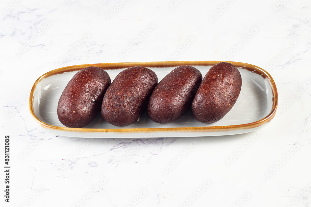 Gulab Jamun, kalo jam or mohan served in tray dish isolated on marble ...