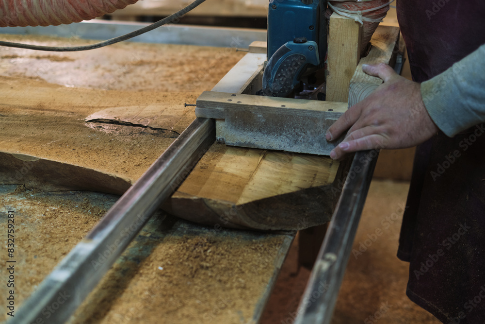 The woodworker carefully cuts through the timber, shaping a future ...