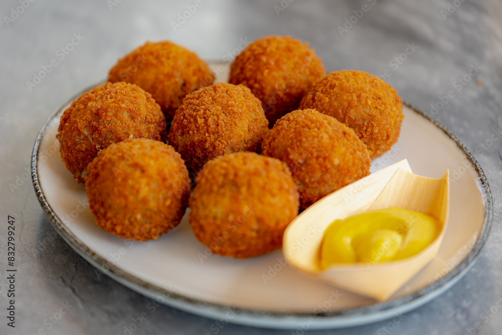 Bitterballen, Dutch meat-based snack in white plate served with yellow ...