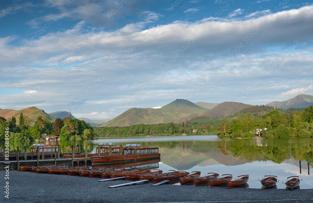 Keswick rowing boats and launches on a calm Derwentwater. Causey Peak ...