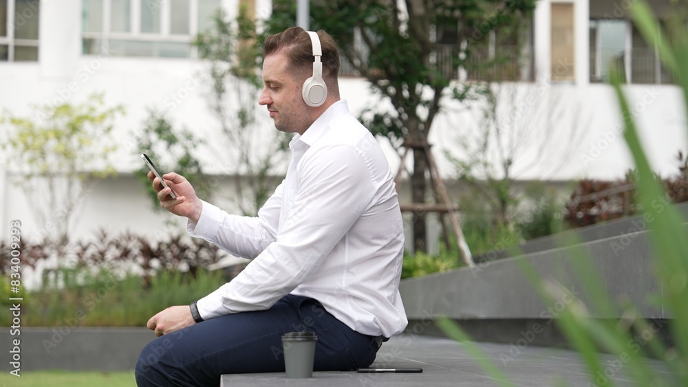 Smart businessman wear headphone to listen relaxed music while take off ...
