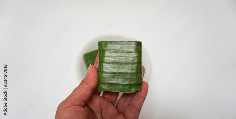 Human hand holding a Lemper, traditional snack from Indonesia. It made ...