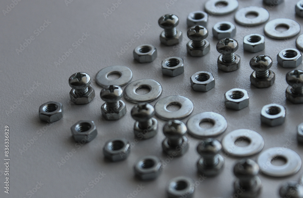 Metal Steel Fastener And Fixing Parts In Even Lines On Plastic Surface ...