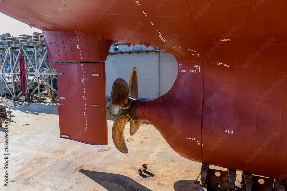 Cargo vessel in dry dock on ship repairing yard. Variable pitch ...