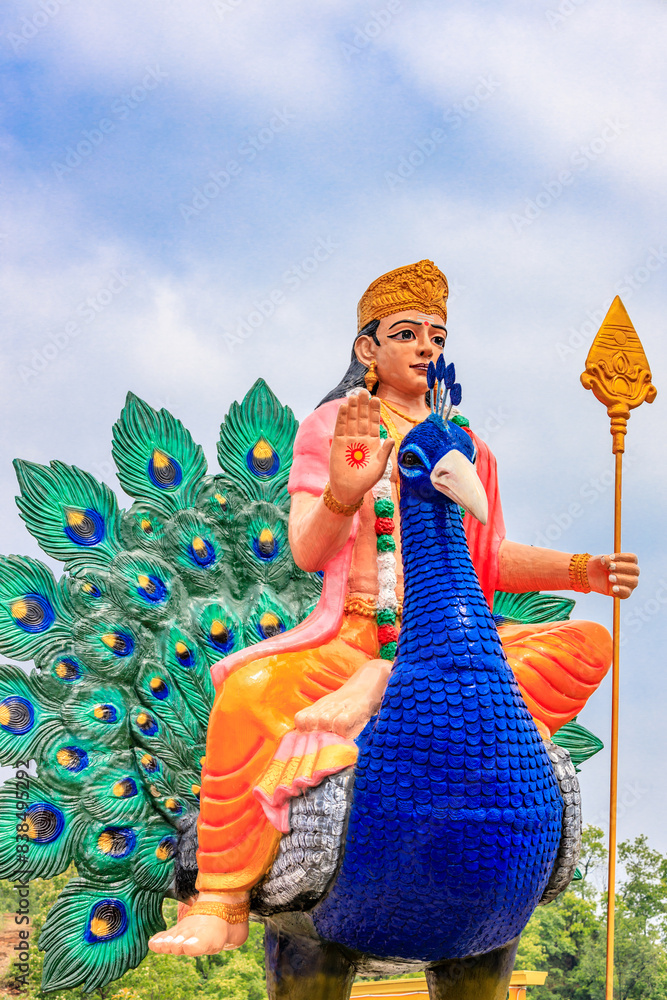 Blue statue of Lord Shiva and other hindu gods seated with a tiger skin ...