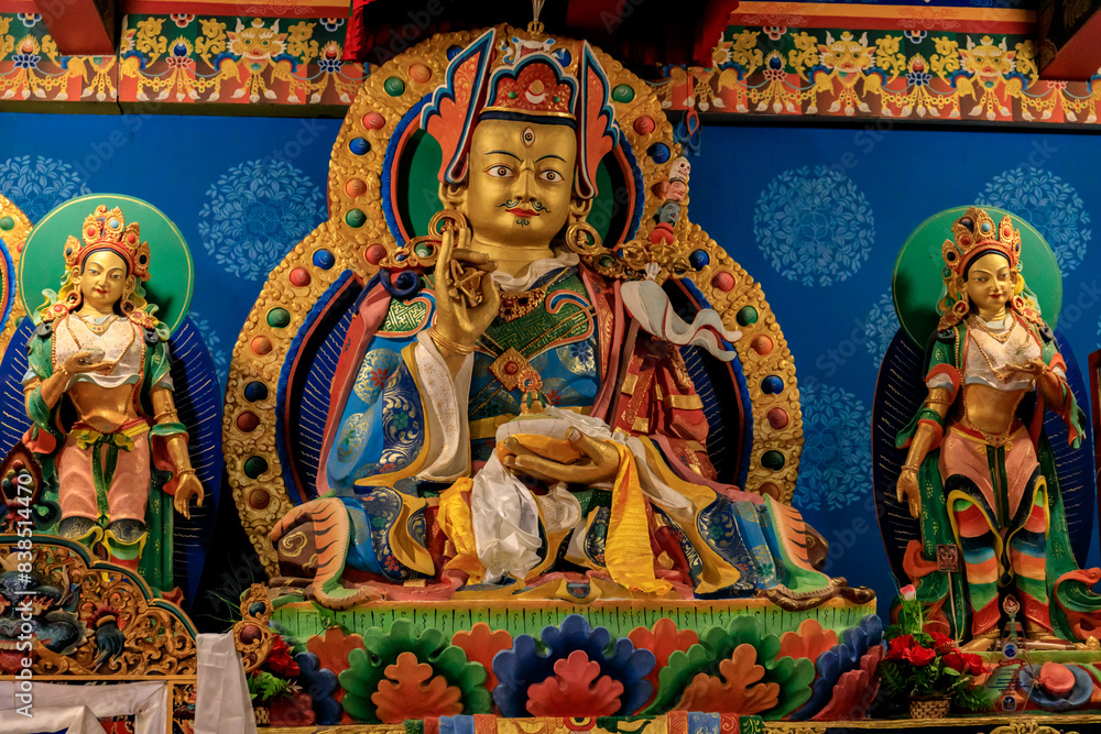 Buddhist temple interior featuring ornate decorations, statues of ...