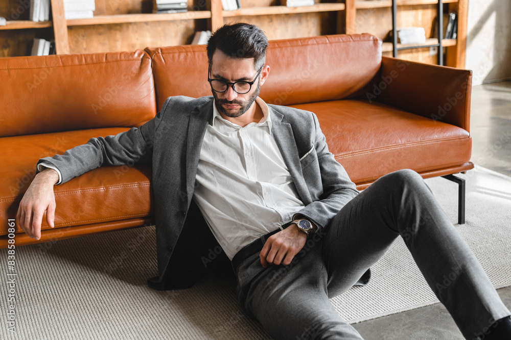 Confident rich businessman relaxing after hard working day at office ...