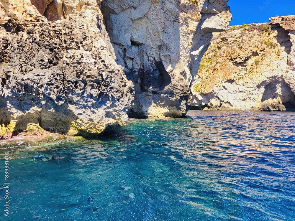 Rocks, caves and blue water. Laying on the pebbles. Water bicycle ...