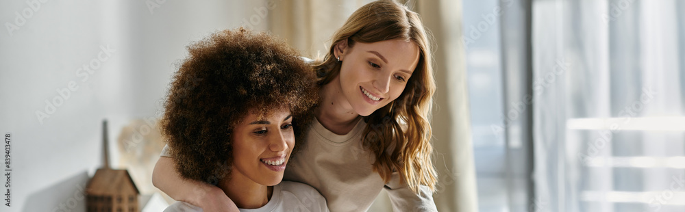Two women, one with long blonde hair and the other with short curly ...