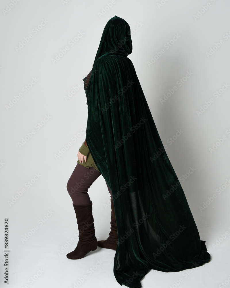 Full length portrait of red haired female model, wearing green medieval ...