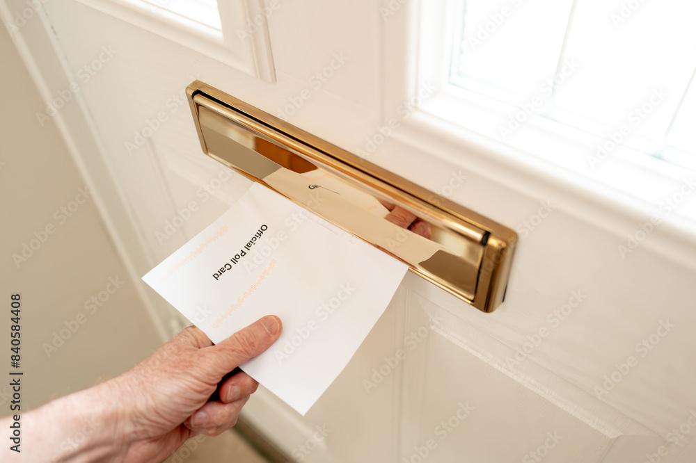 Homeowner seen pulling a UK 2024 Official Polling Card letter through ...