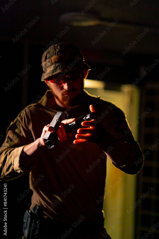 at a professional shooting range a military trainer reloading a pistol ...