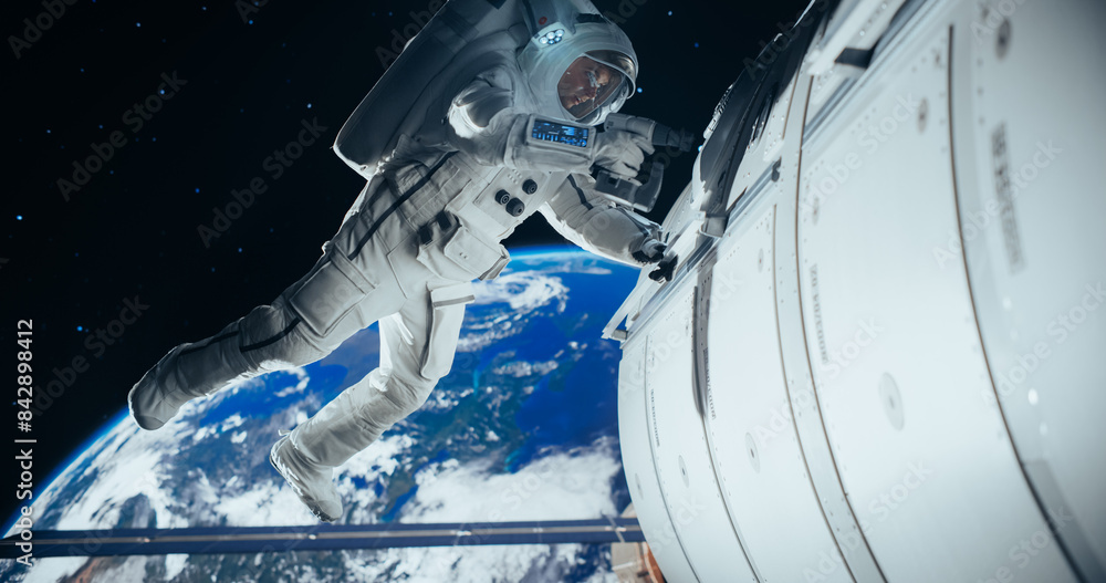 Professional Space Engineer Servicing a Panel on a Communication ...