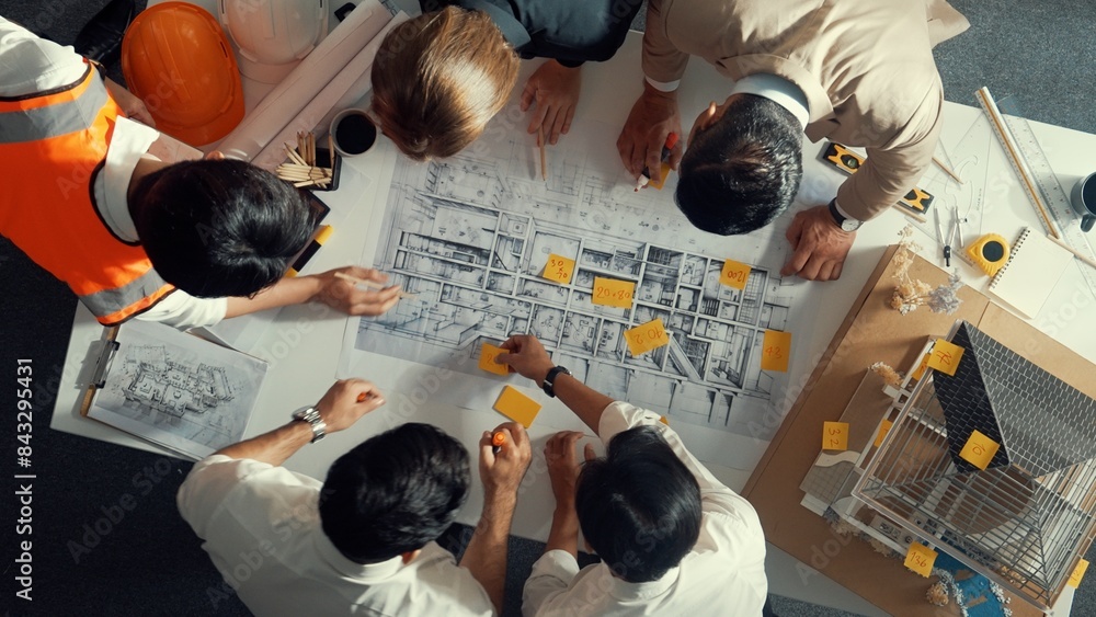 Top down view of skilled engineer team compare between blueprint and ...