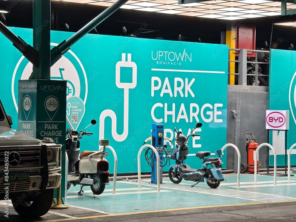 BGC, Taguig, Metro Manila - May 24, 2024: An electric vehicle charging ...