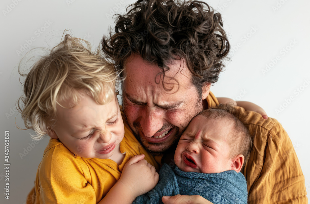 A man holding two children, one with blonde hair and the other just ...