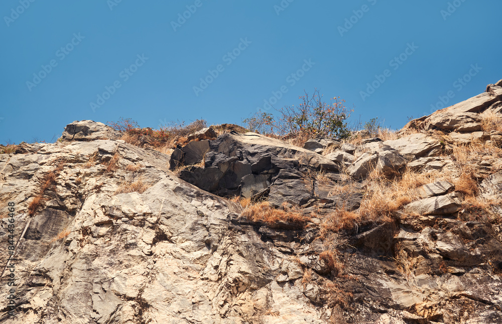 rough textured walls of rocky cliff surrounding Marble Lake in ...