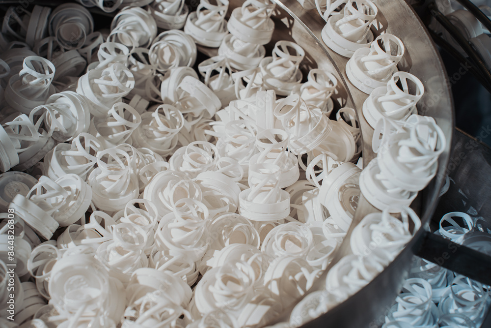 Mass production of caps for pharmaceutical containers. White plastic ...